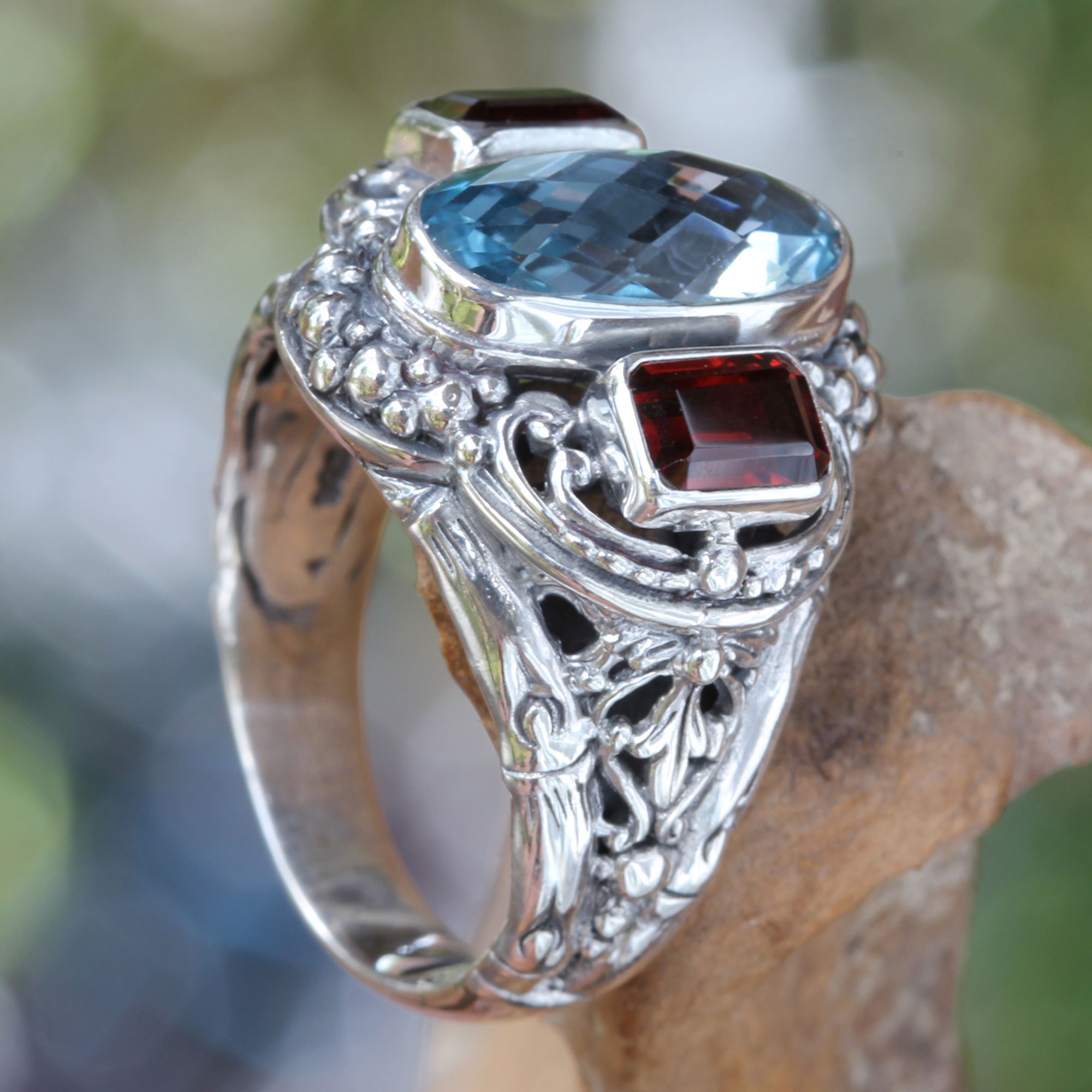 Blue Topaz and Garnet Silver Cocktail Ring from Bali - Limpid Pool | NOVICA